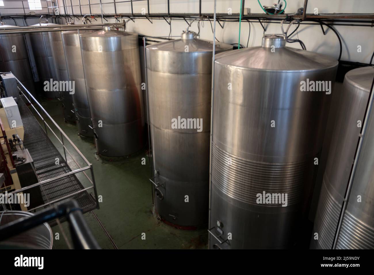 Making wine on traditional bodega in steel tanks and old wooden barrels ...