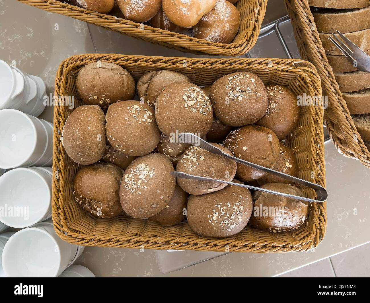 Delicious buns are on the table in a wicker basket. Top view, close-up ...