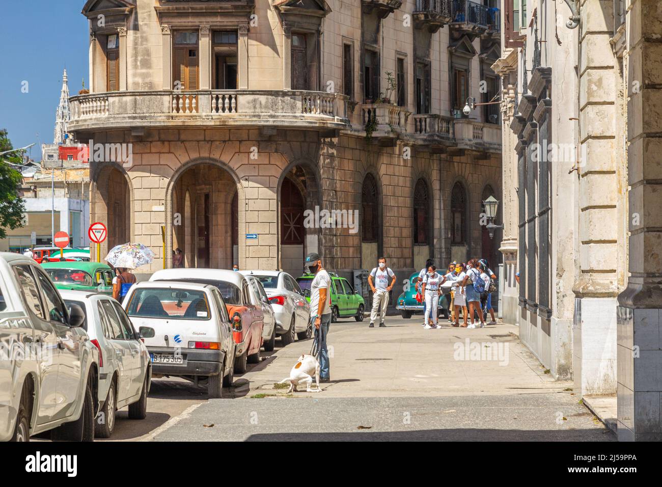 Cuban people wearing face masks are seen in the broad sidewalk that ...