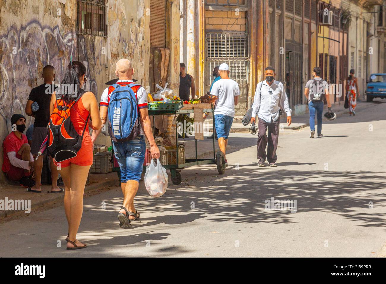 Cuban people are seen in their normal routine in a city street. The are ...