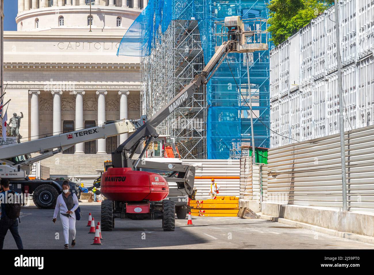Construction equipment are working in a construction site across El ...