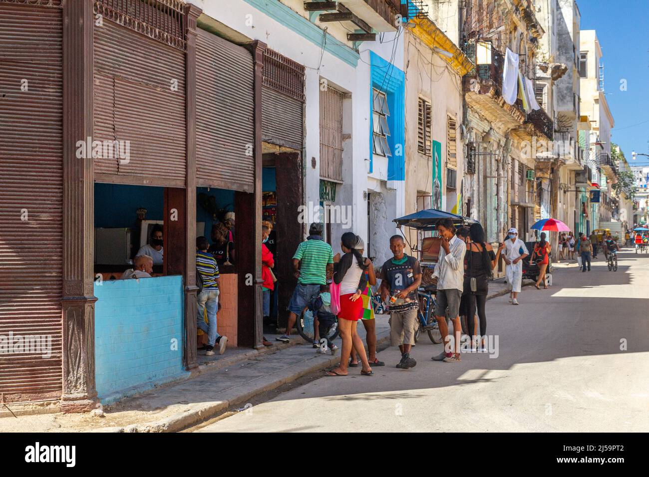 A group of Cuban people in their normal lifestyle or routine are seen ...