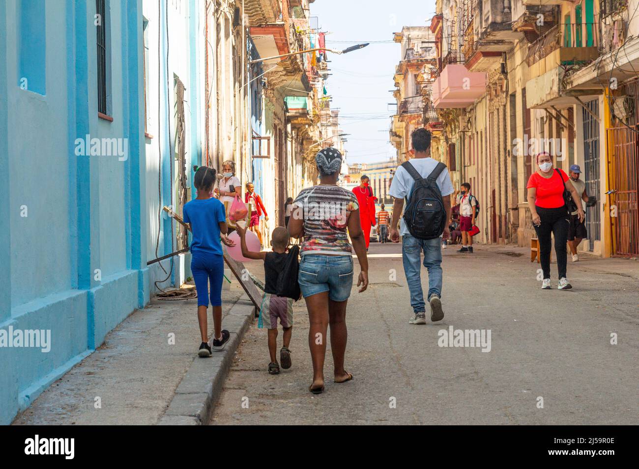 Group of Cuban people in a city street. The traditional weathered ...