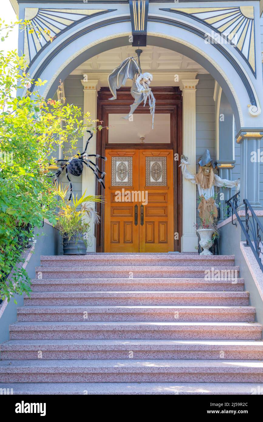 Perron stairs at the front of the porch with huge wooden double door at ...