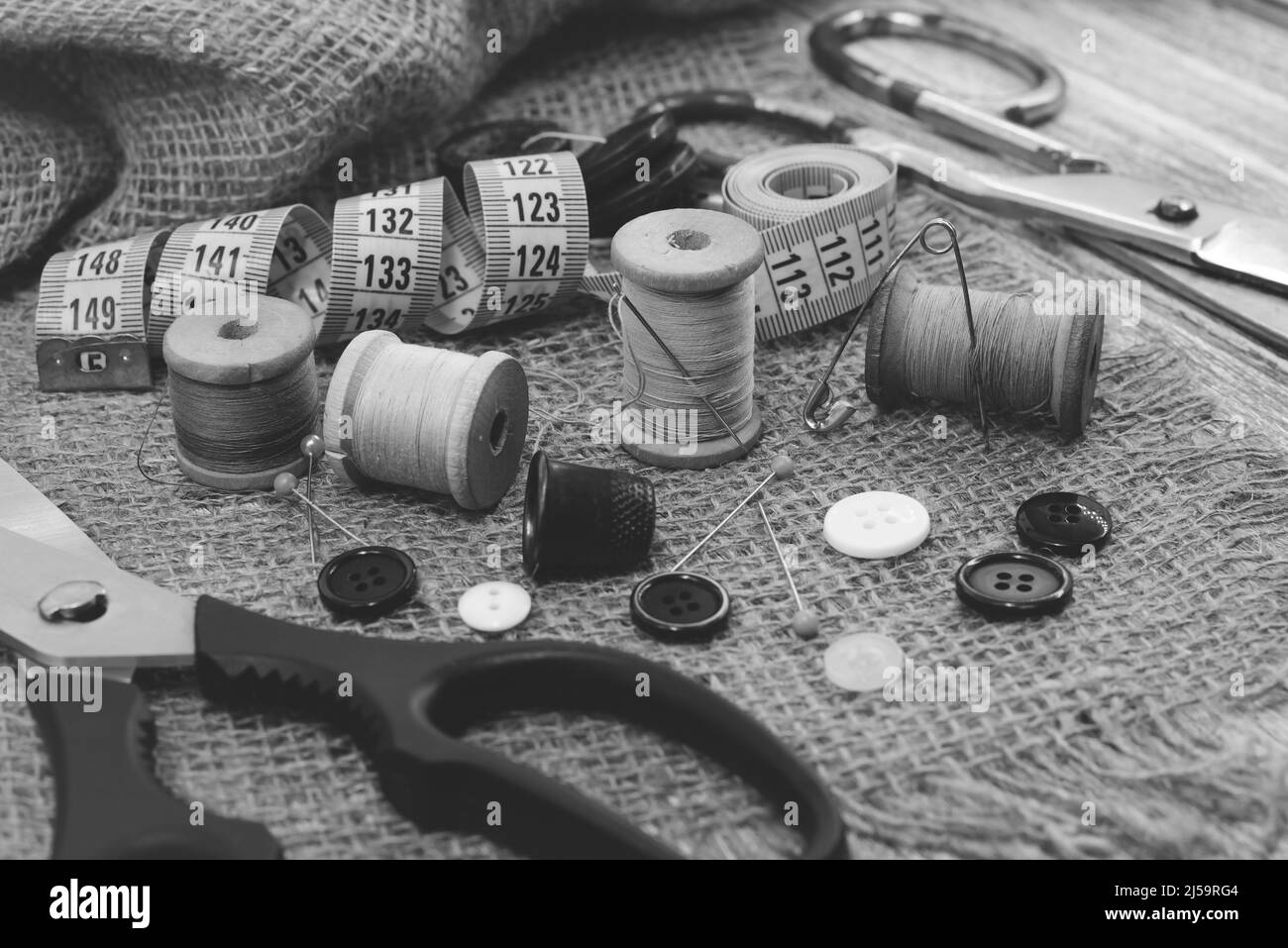 Retro tools for cutting and sewing. Needle with thread, thimble, sewing ...