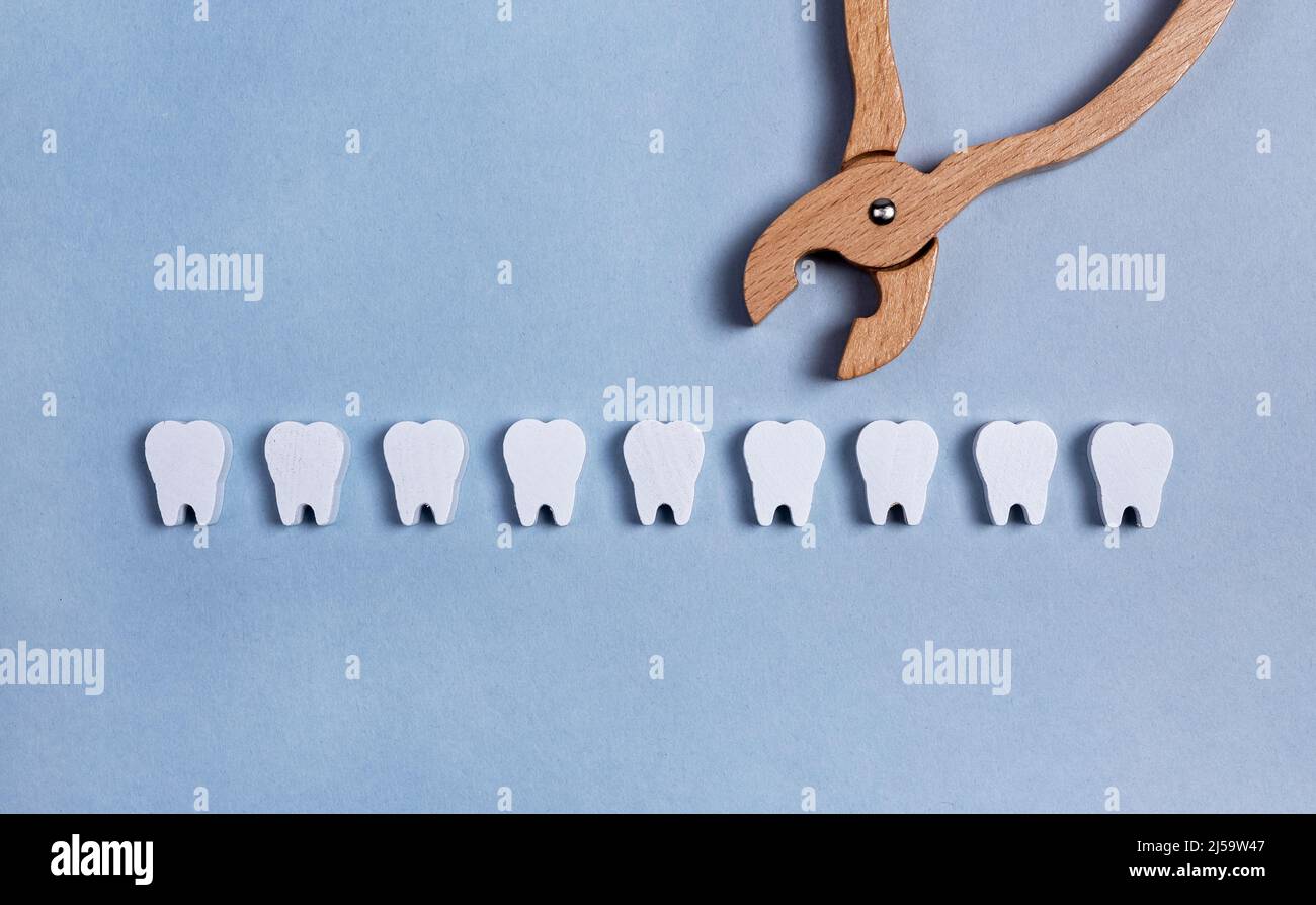 Teeth row with forceps. Surgical tooth extraction or dental ...