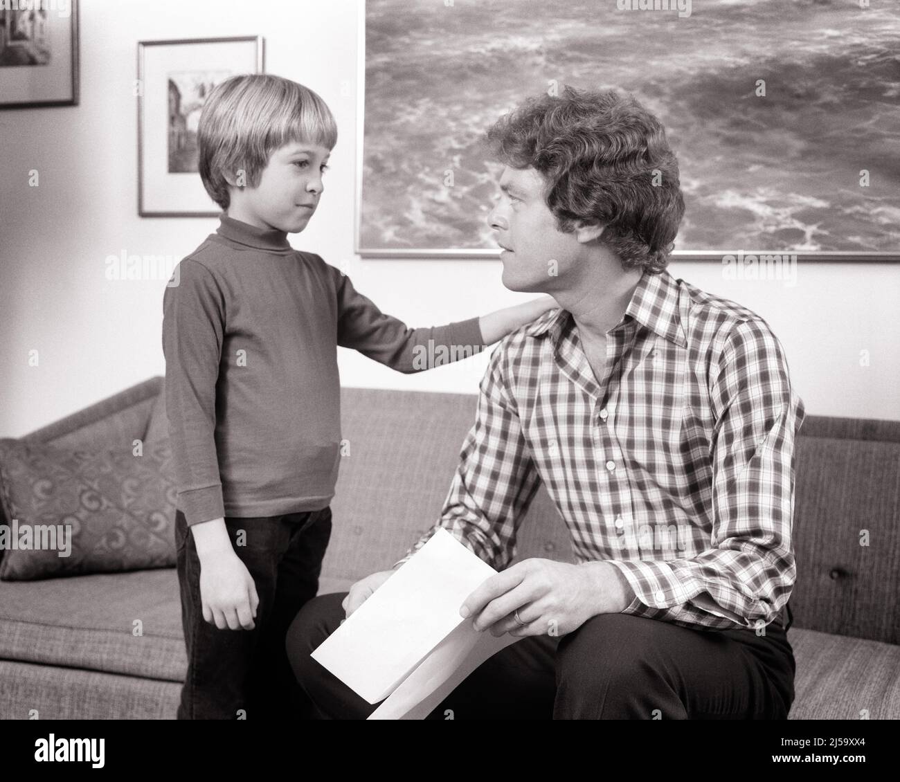 1970s FATHER & SON HAVING A TALK FATHER HOLDING LETTER SCHOOL NOTE OR ...