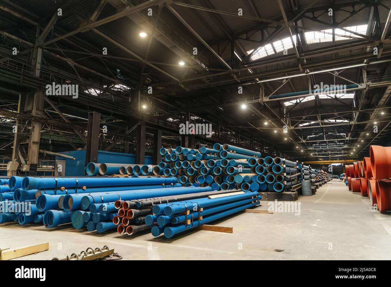 Many blue steel pipes for water pipeline in factory warehouse Stock ...