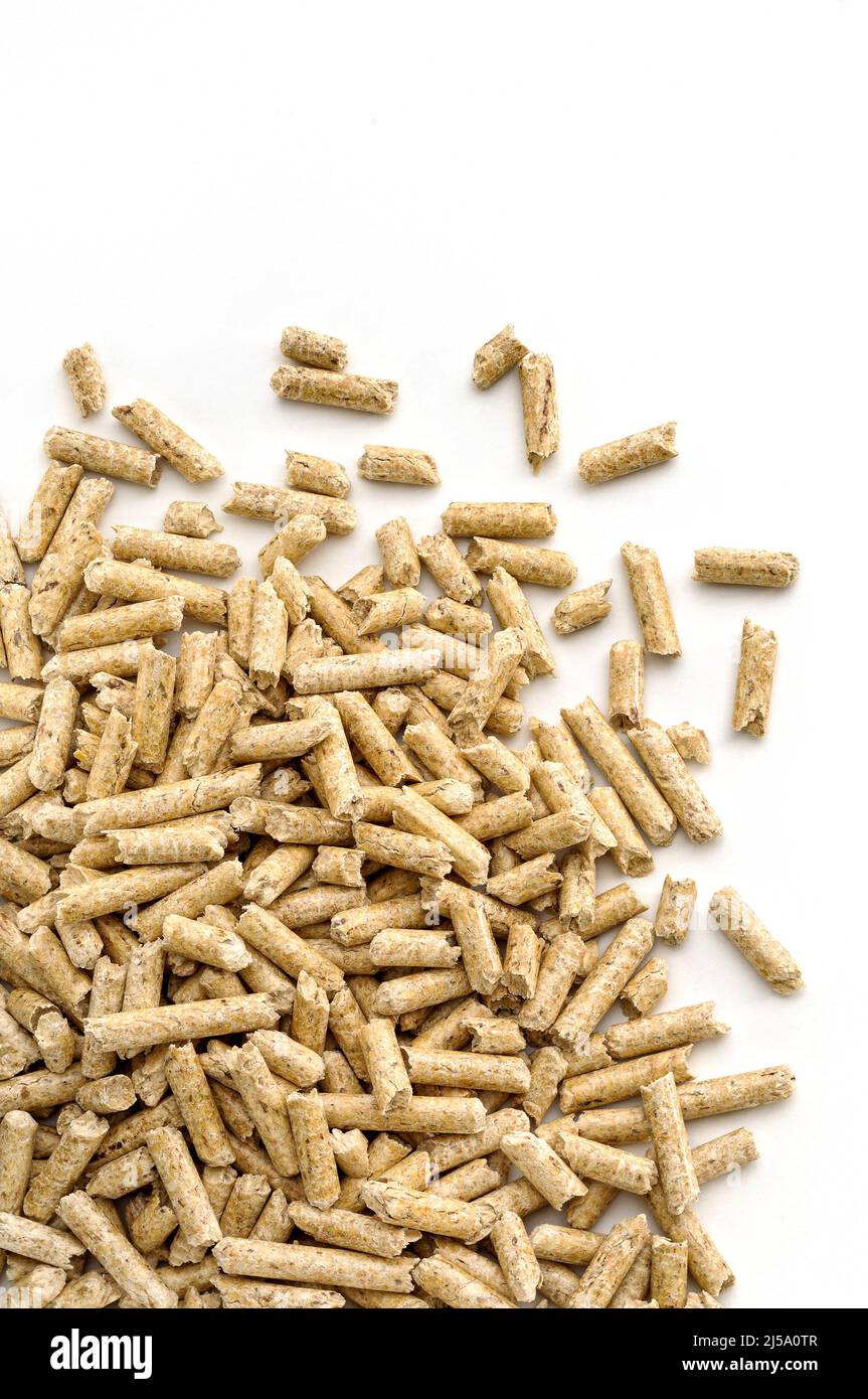 Wood pellets for heating, placed in the corner of a white background ...