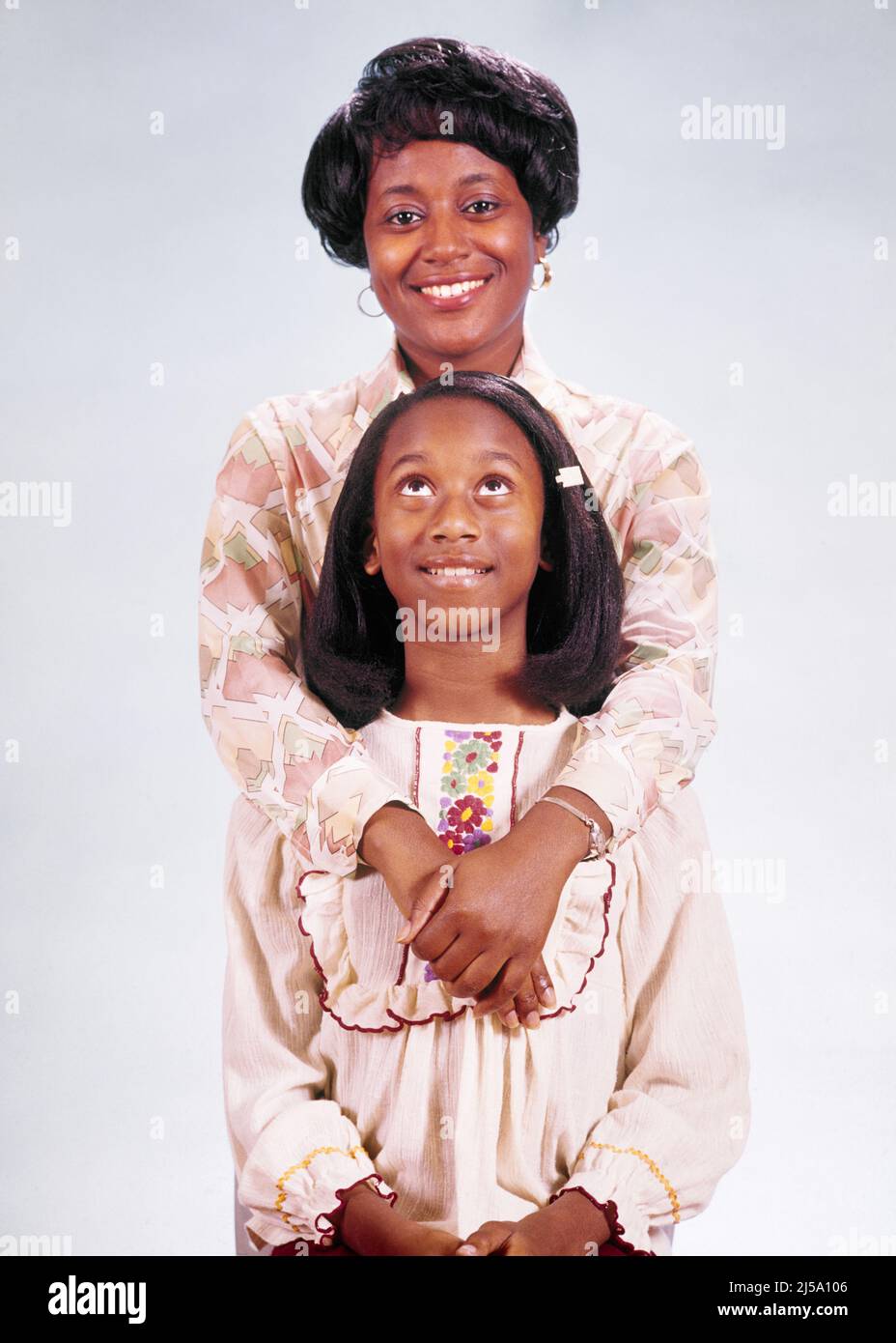 1970s PORTRAIT AFRICAN-AMERICAN MOTHER LOOKING AT CAMERA WITH HER ARMS ...