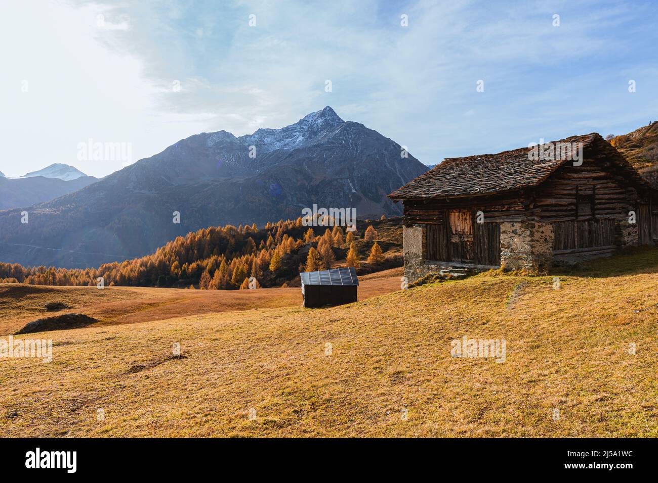 a mountain pasture and a high mountain village with typical wooden and ...