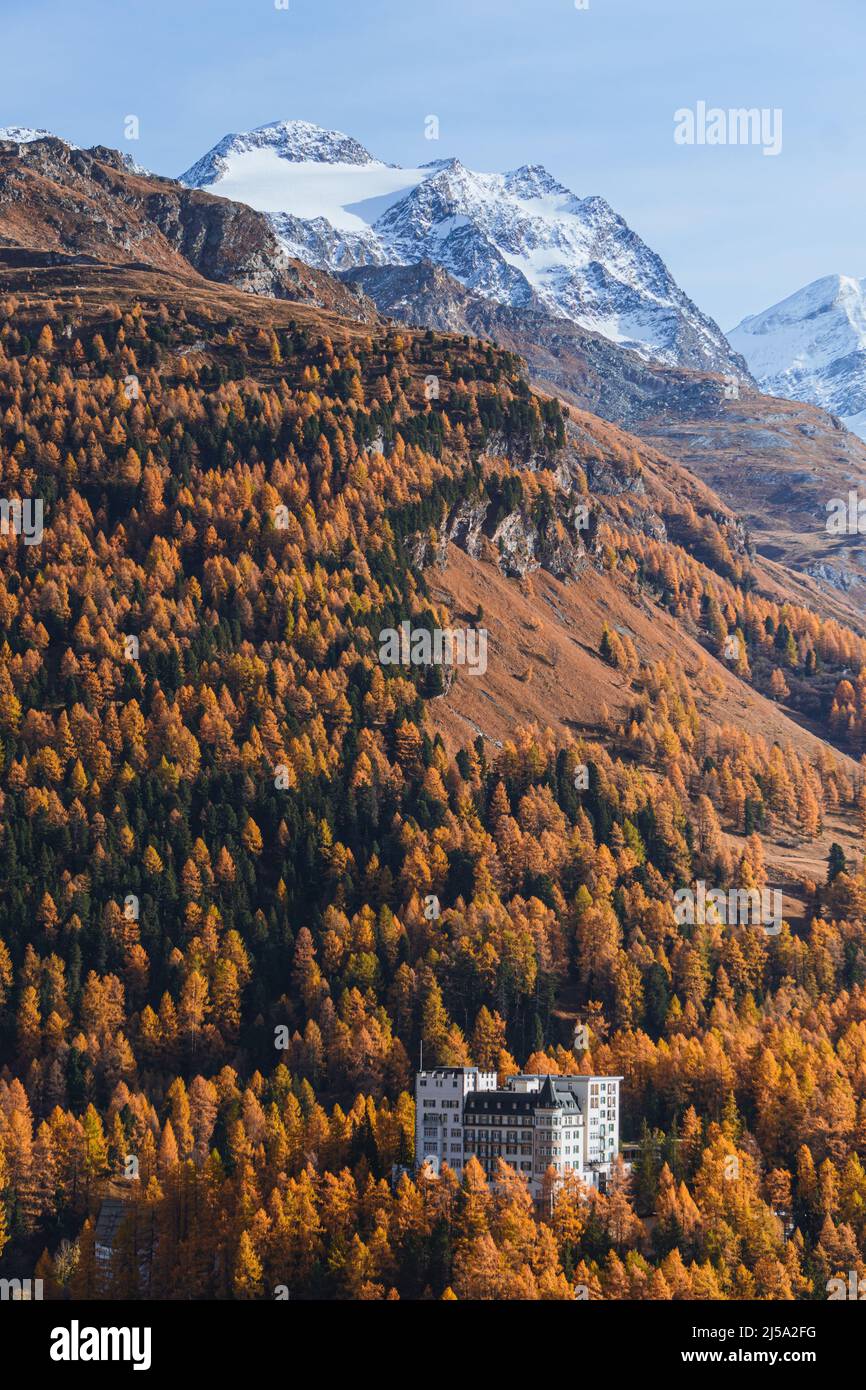 A castle at sunset immersed in the autumn colors of the swiss alps ...