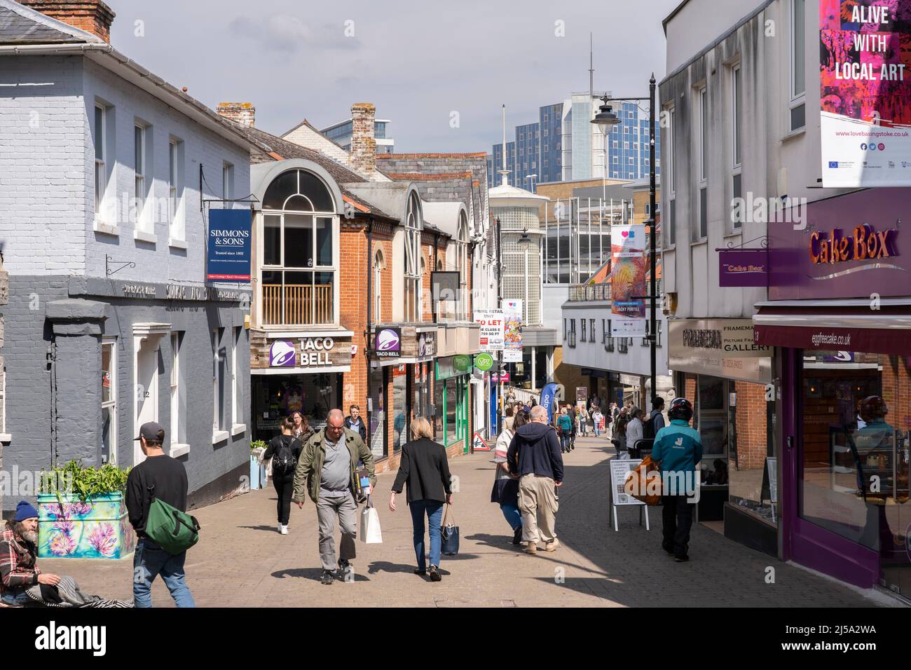 Pedestrians and shoppers on Wote Street in Basingstoke town centre in ...