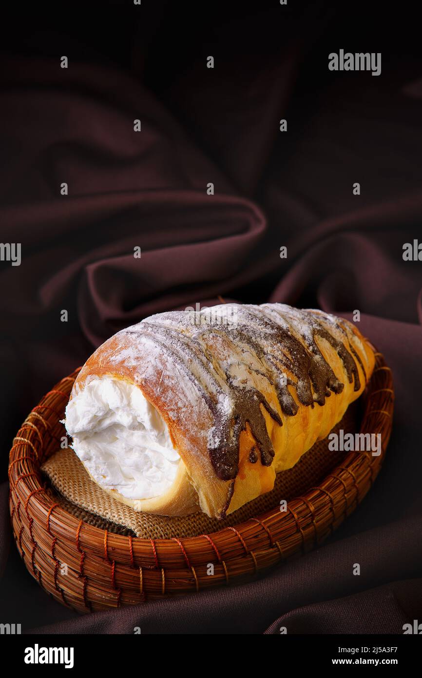 delicious cone-shaped bread rolled up filled with pastry cream covered ...