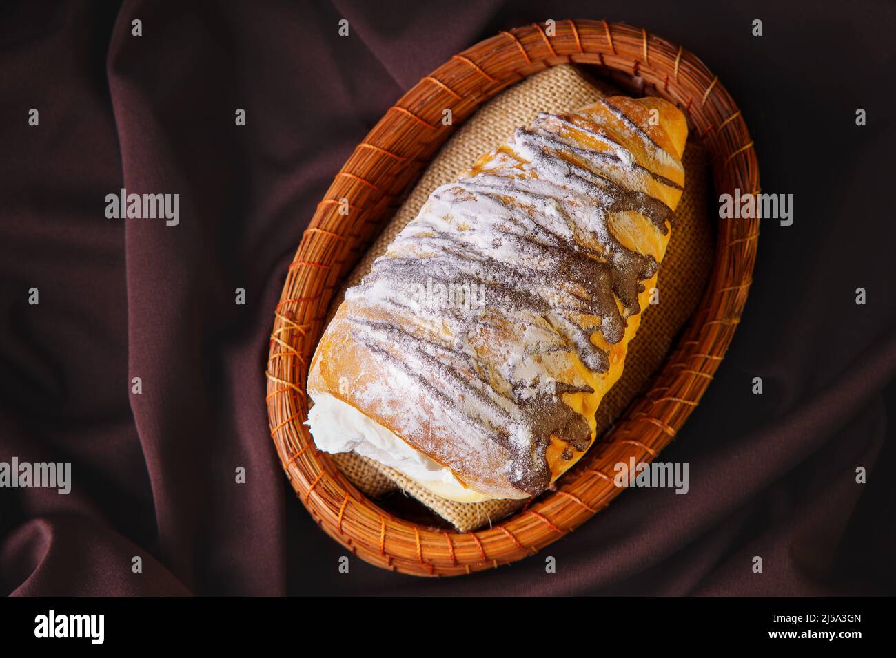 delicious cone-shaped bread rolled up filled with pastry cream covered ...