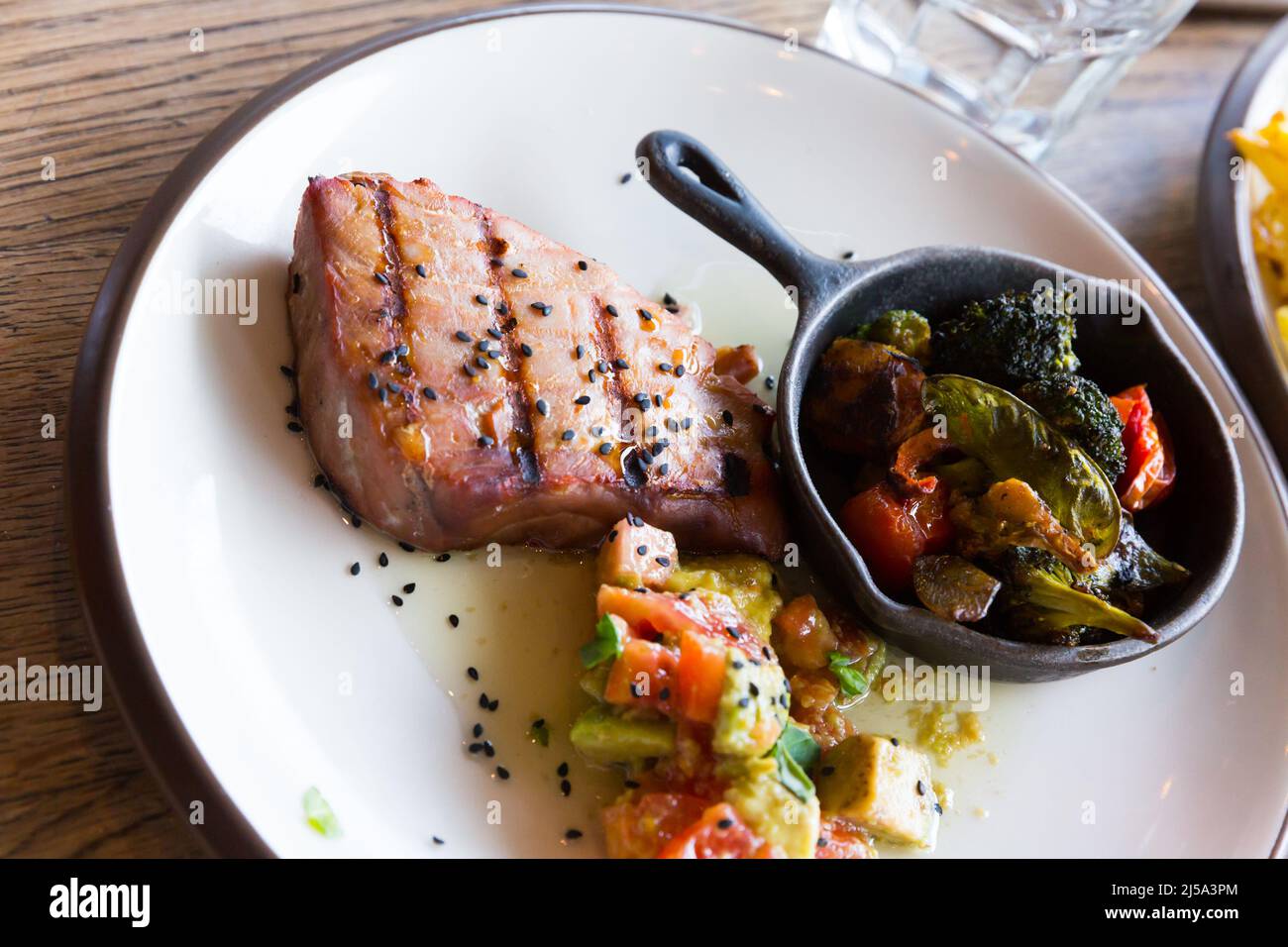 Grilled tuna fillet with avocado, tomatoes Stock Photo - Alamy