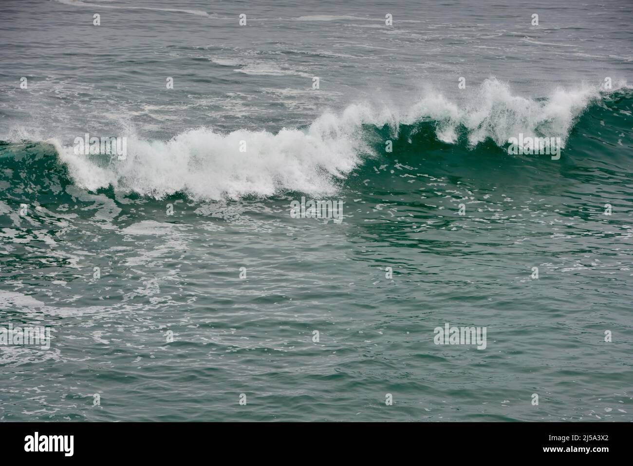 Surf Breaking. Waves break and crash on a rough sea Stock Photo - Alamy