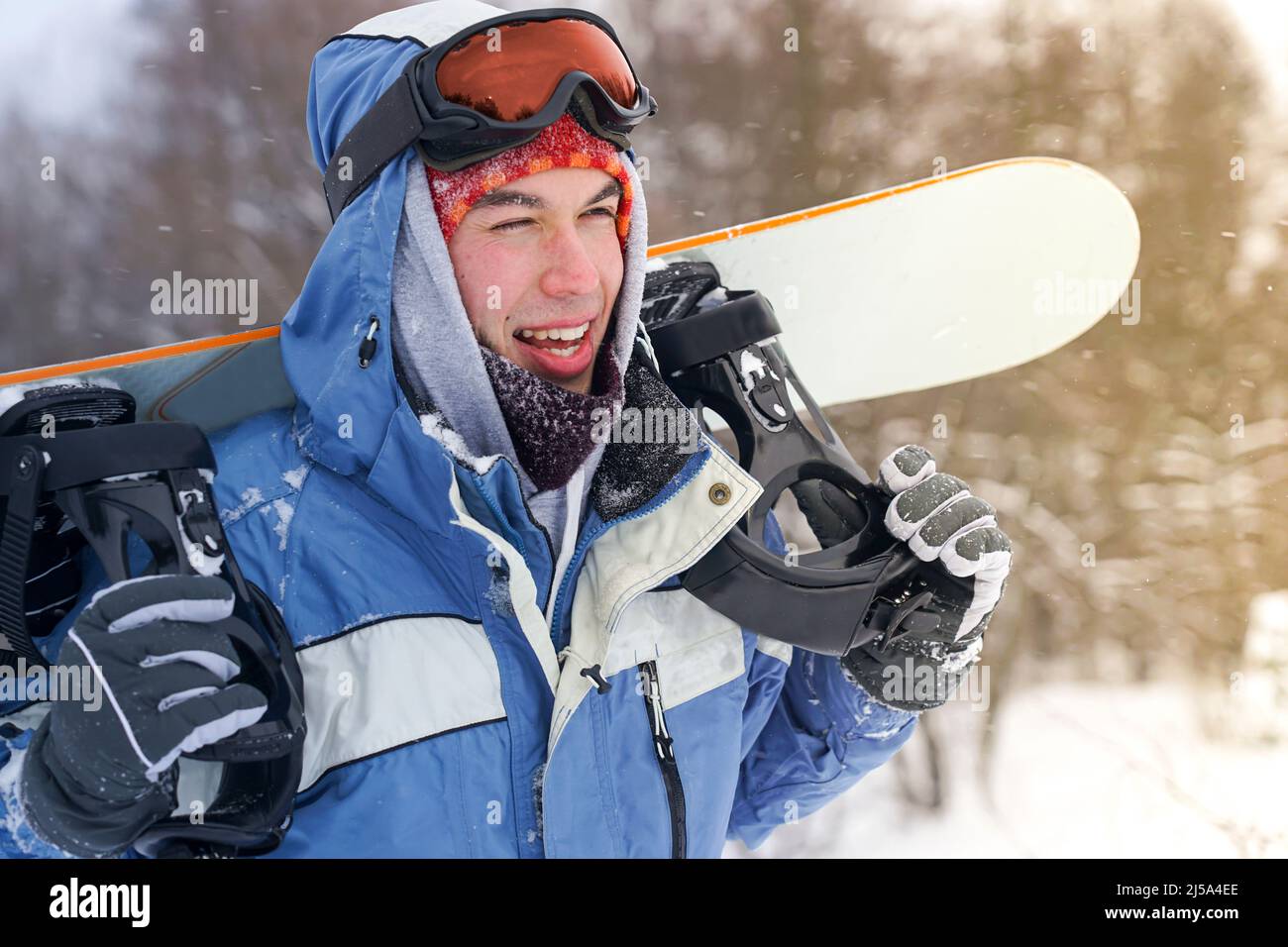 Portrait of a snowboarder on a snowy slope. Freerider with a snowboard ...