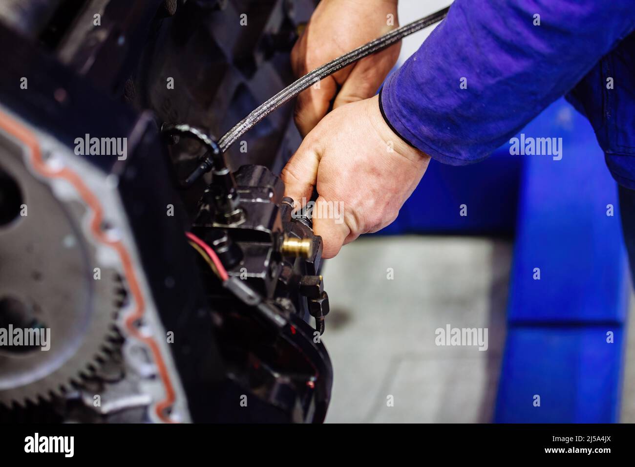 Industrial worker assembles machine, close up Stock Photo - Alamy