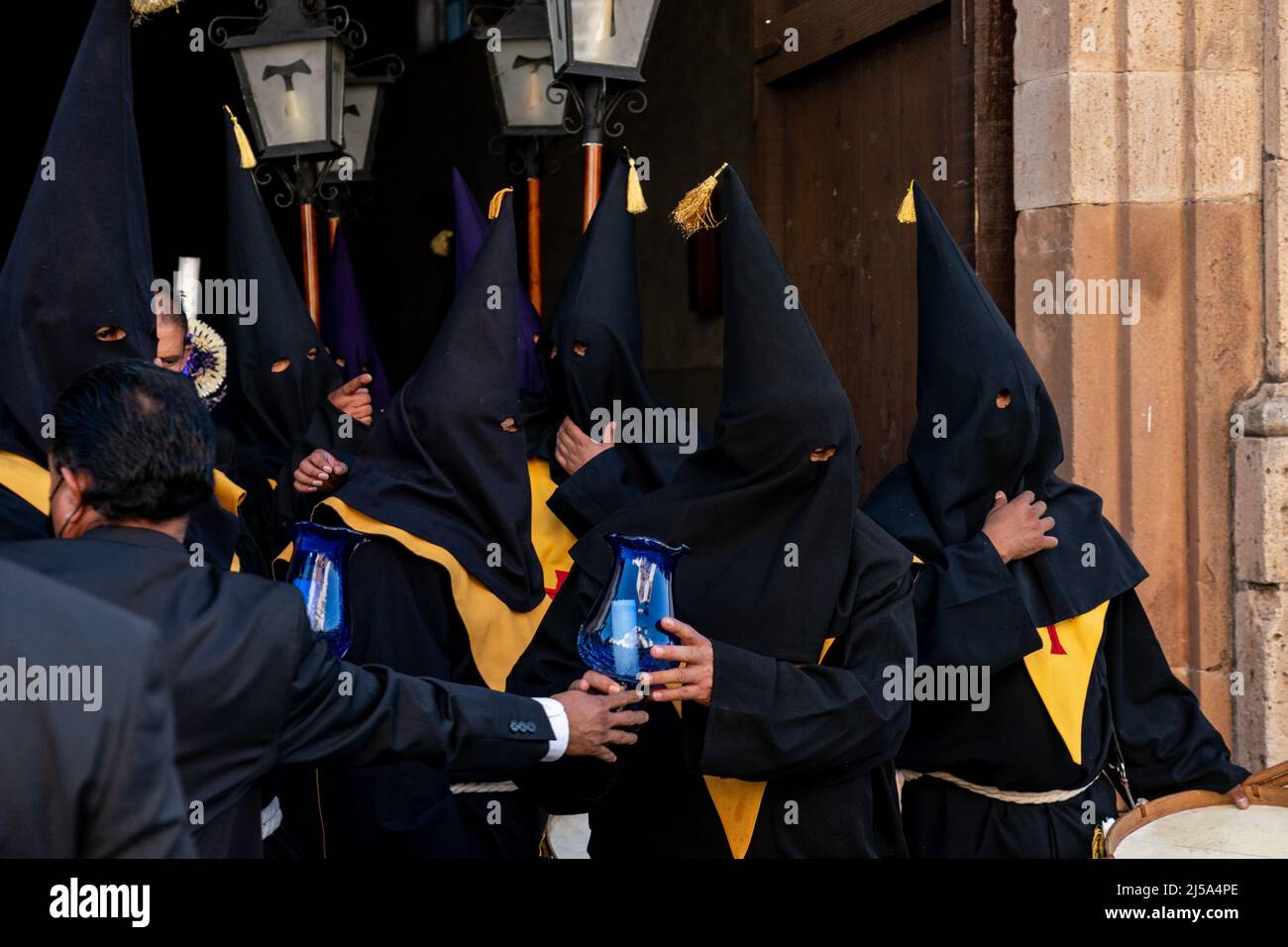 Roman Catholic hooded penitents wearing traditional capirotes, began ...