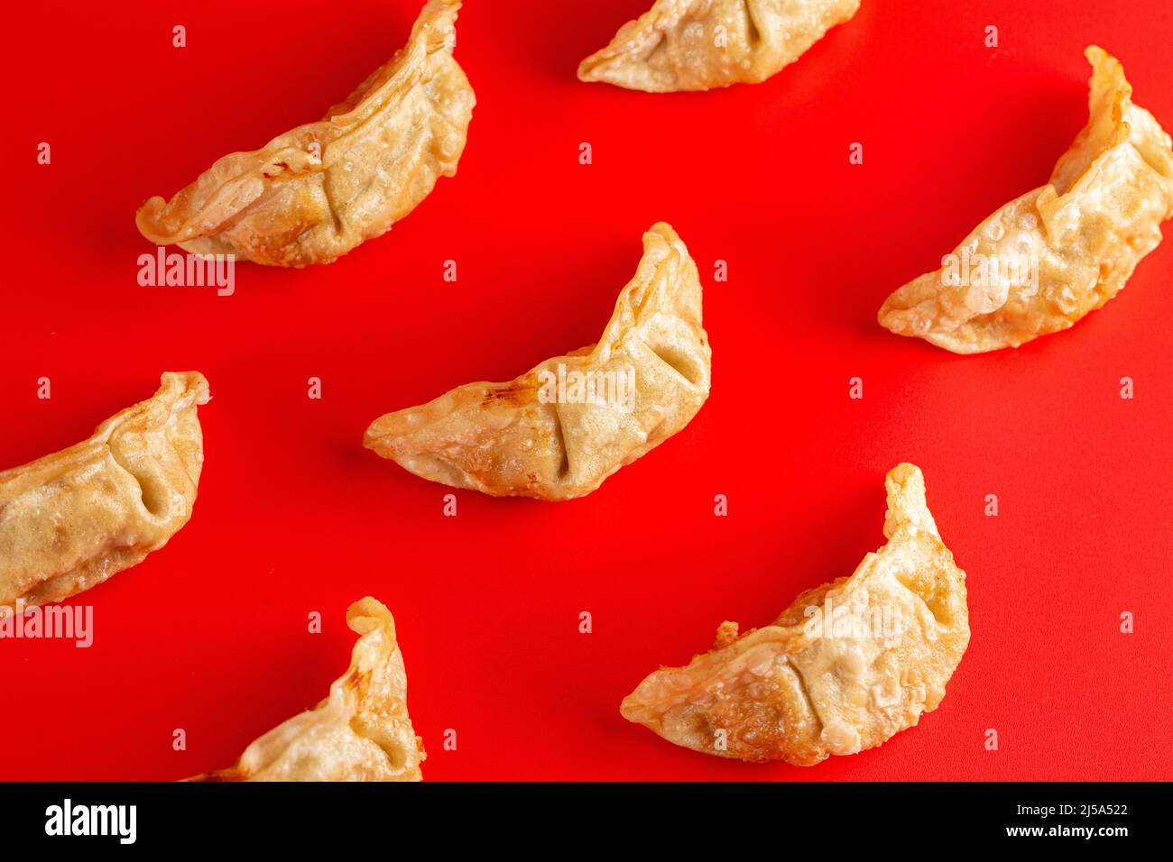 A Background of Pork Potstickers Dumplings on a Bright Red Background ...