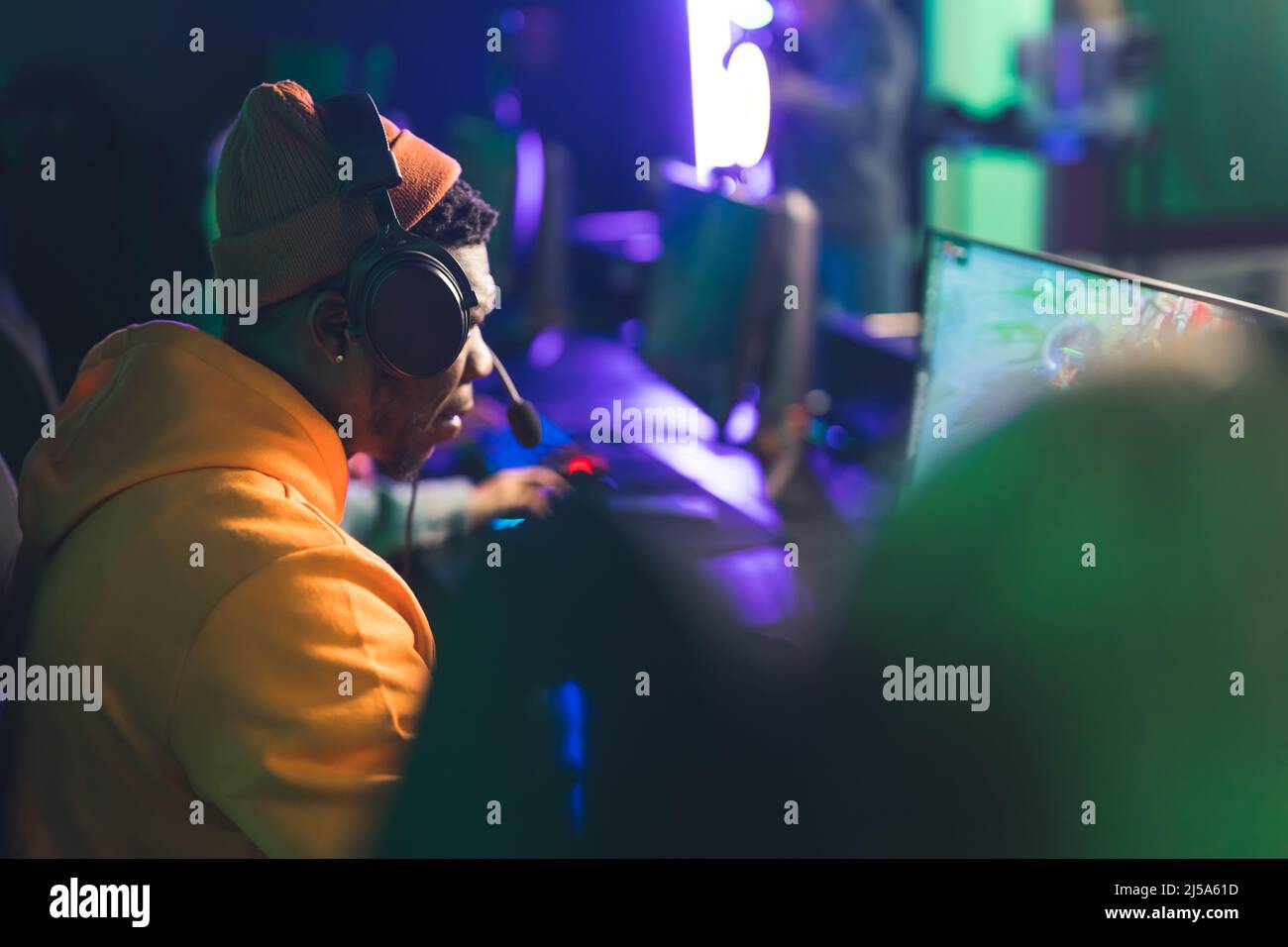 Blurred view of an African-American male gamer influencer spending time ...