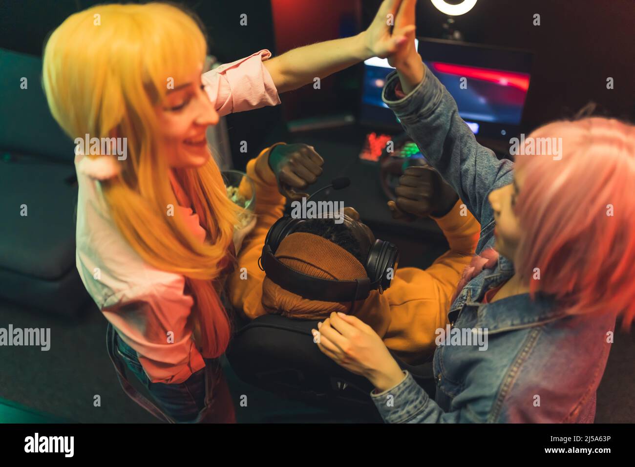 High five, victory. Young adults are happy after one of their friends ...