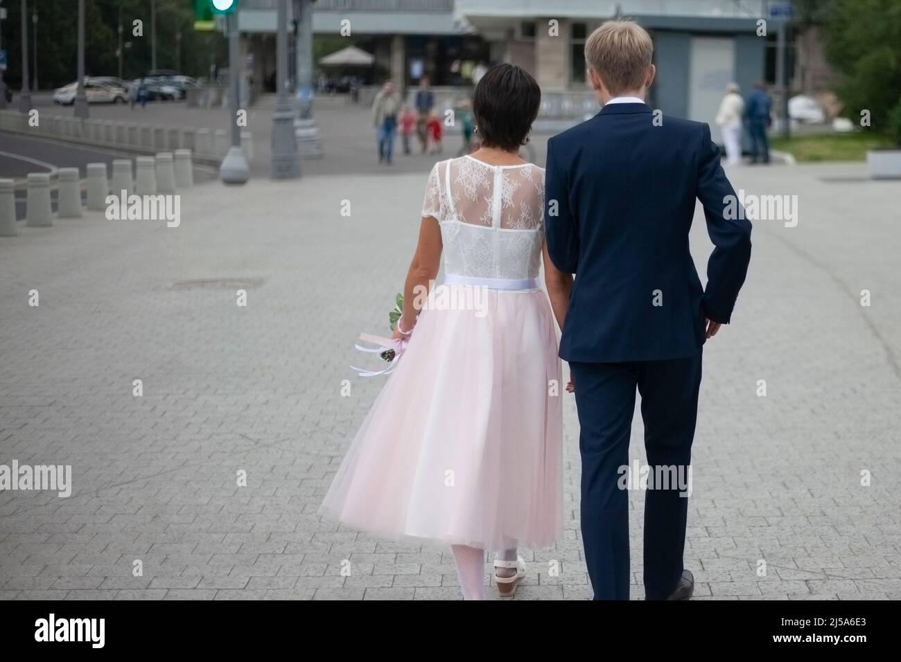 Bride and groom hold hands. Girl in white dress. Details of celebration ...