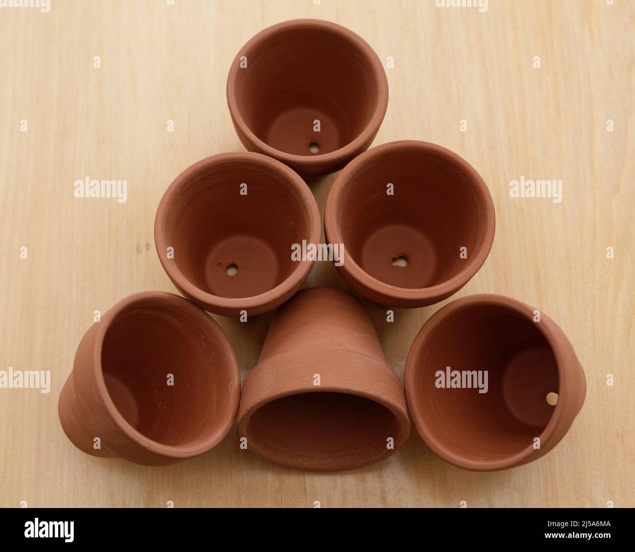 Different angles of terracotta pots waiting to be filled with potting ...