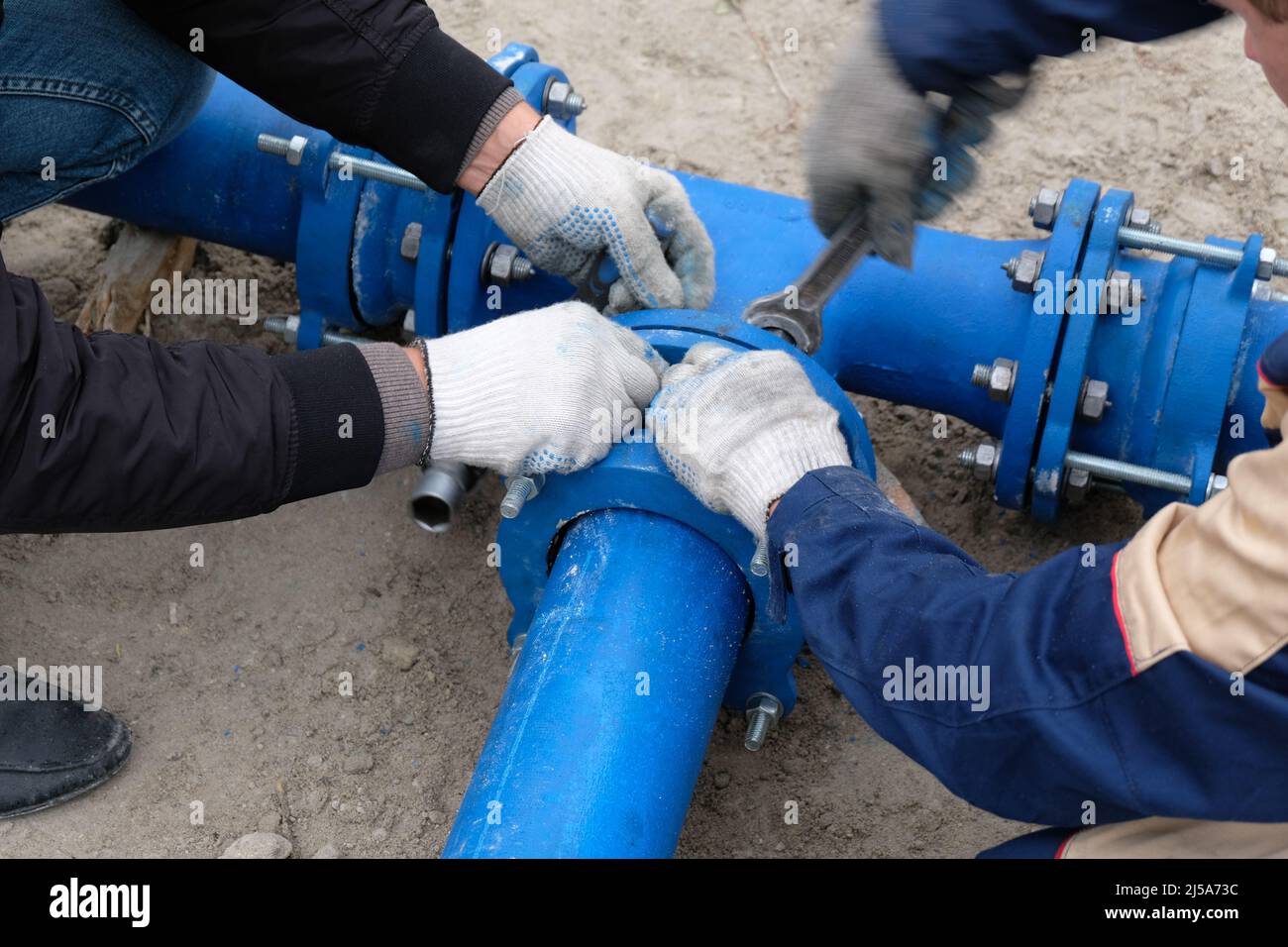 Workers installing water supply pipeline system, close up Stock Photo ...