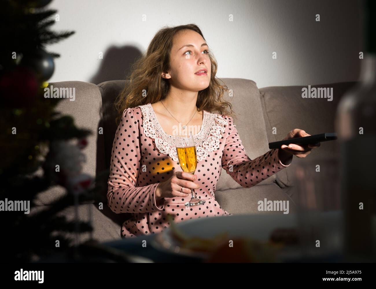 Smiling woman watching tv Stock Photo - Alamy