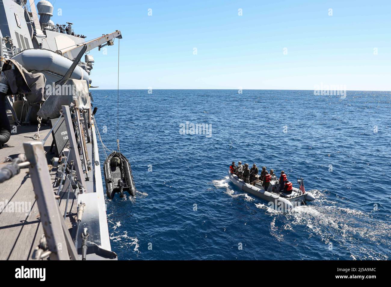 Rigid hull inflatable boat lowered from hi-res stock photography and ...