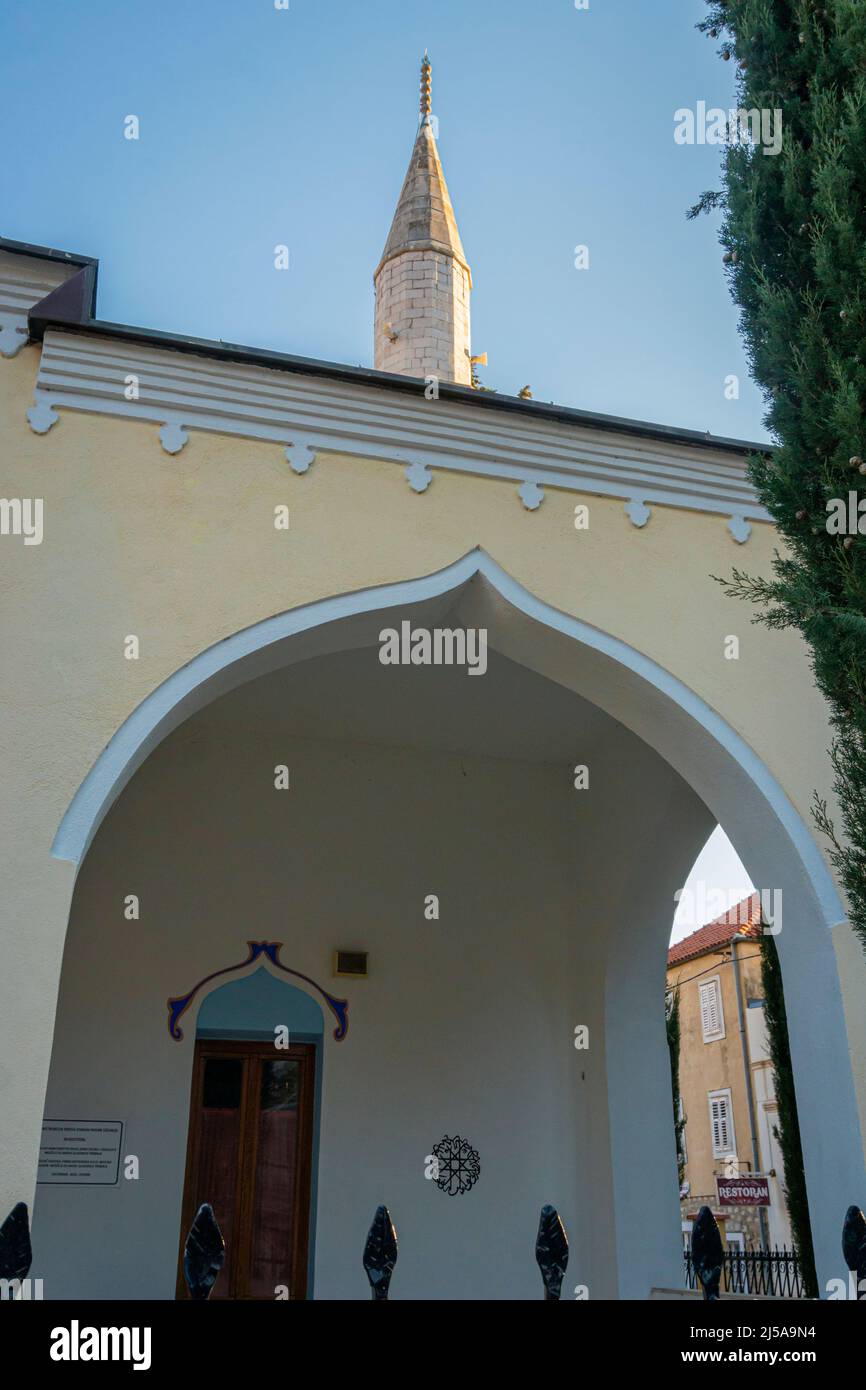 Arch and tower of Osman Pasha mosque in the old town of Trebinje ...