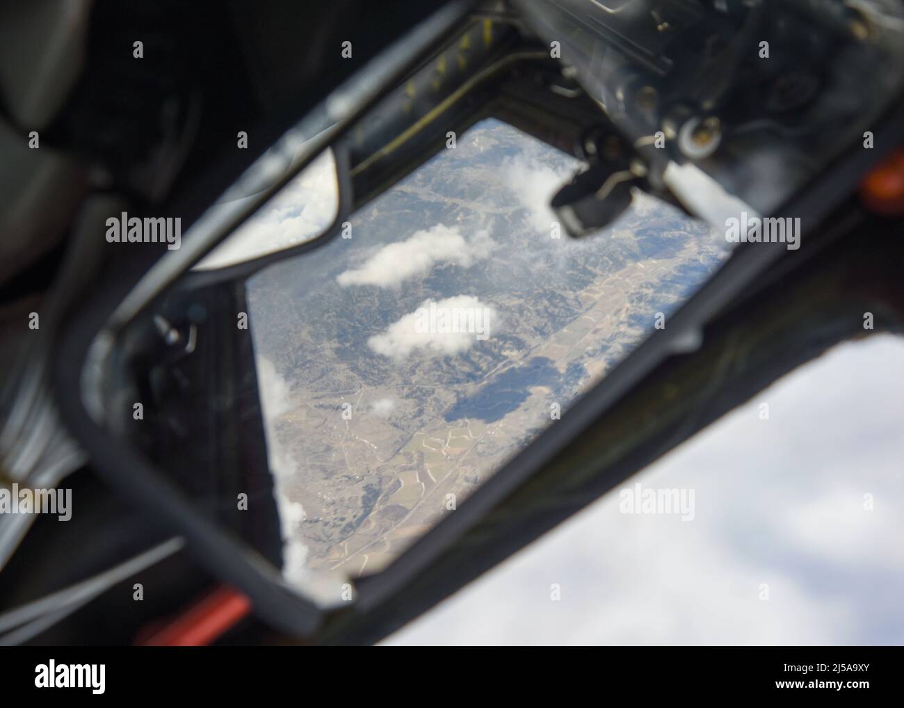 The ground view is reflected in a mirror inside the boom pod of a KC ...
