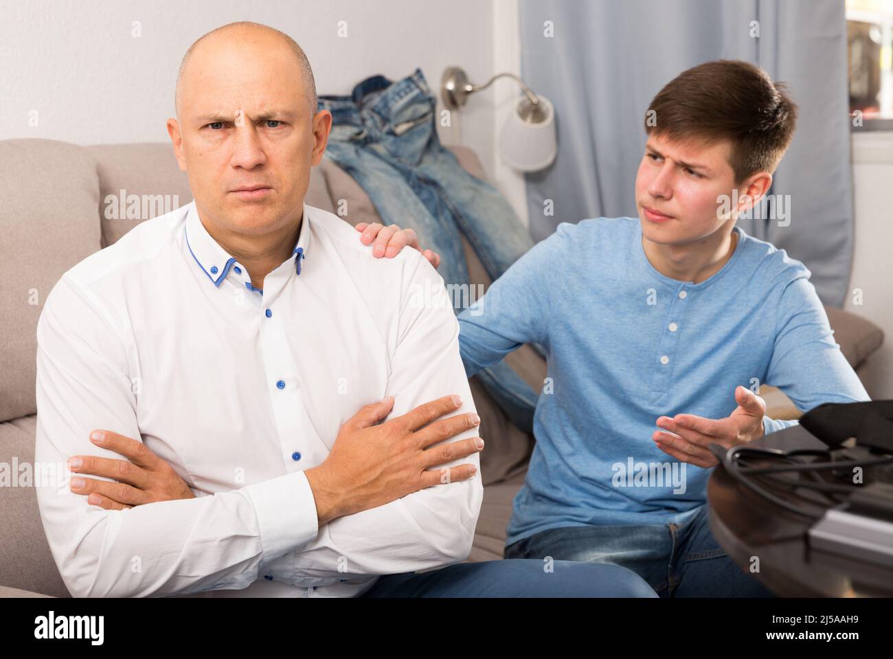 Son apologizing to father Stock Photo - Alamy