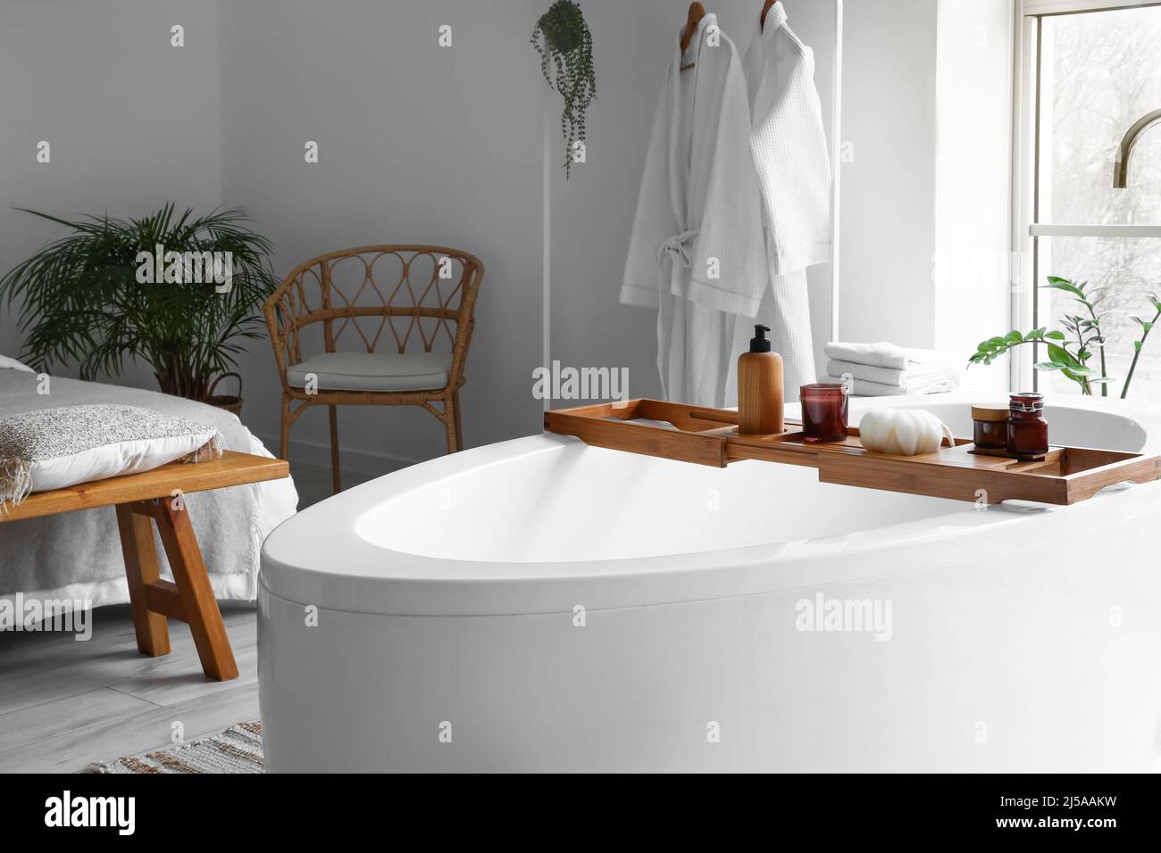 Stylish interior of bedroom with bathtub, closeup Stock Photo - Alamy