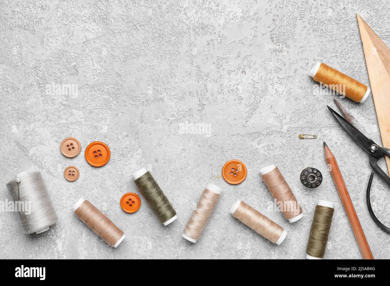 Sewing threads, buttons, scissors and ruler on grey background Stock ...