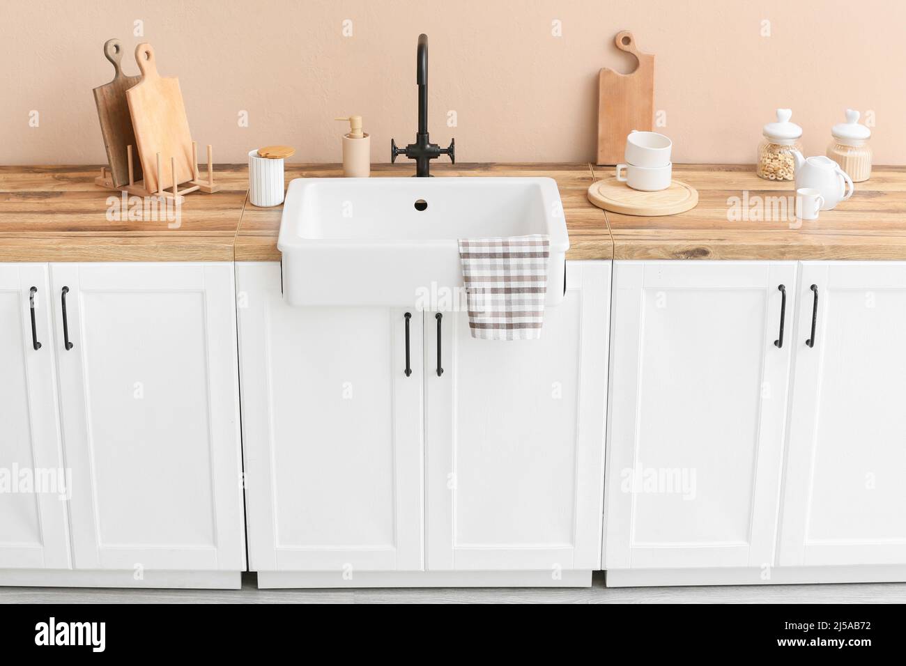 Wooden counter with ceramic sink in kitchen Stock Photo - Alamy