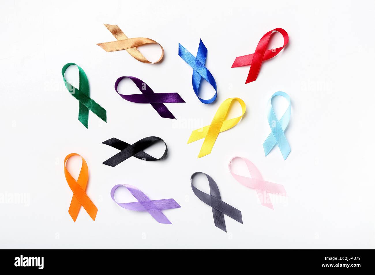 Different scattered awareness ribbons on white background. World Cancer ...