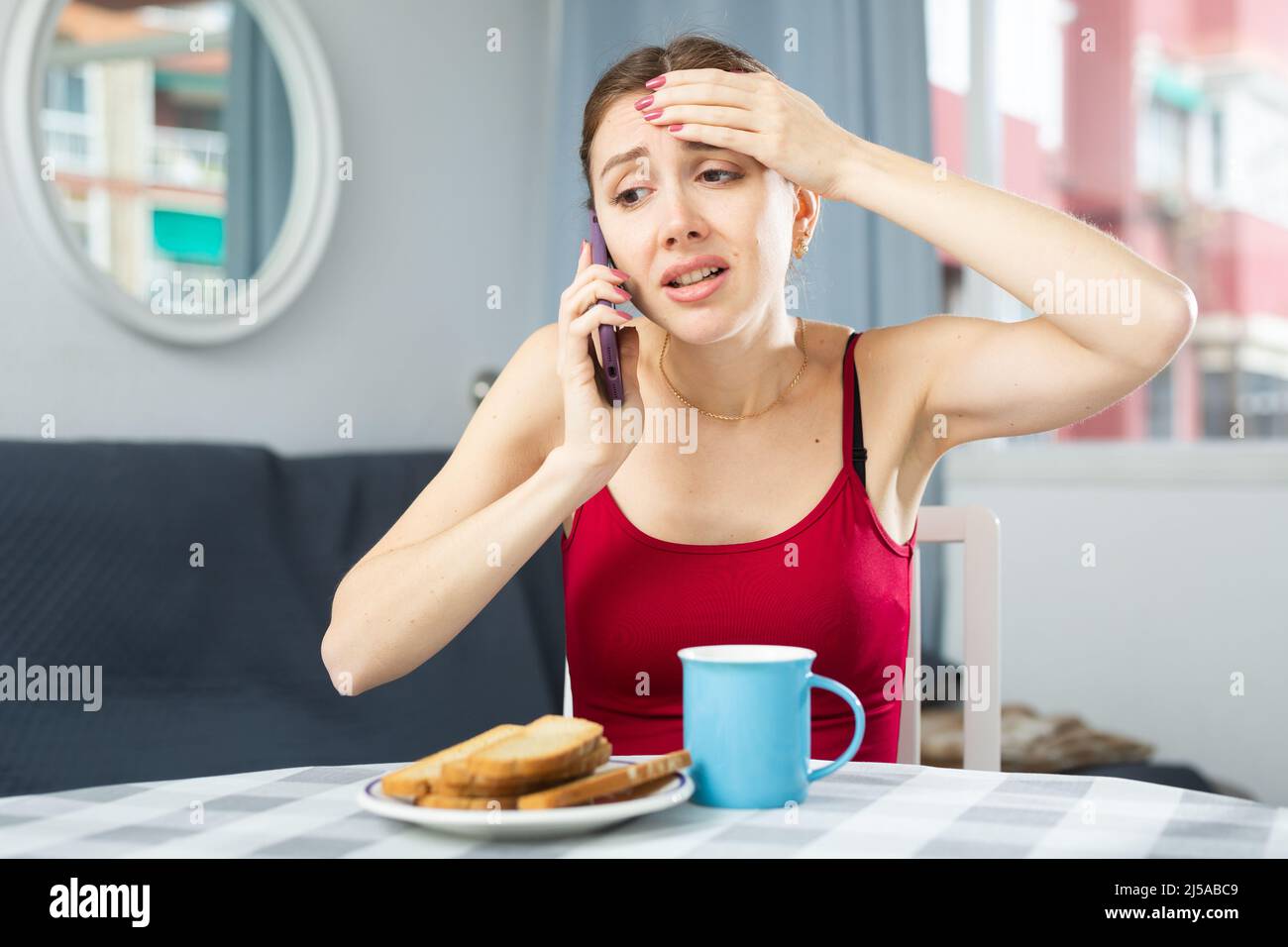 Caucasian woman having fever sitting and talking on phone Stock Photo ...