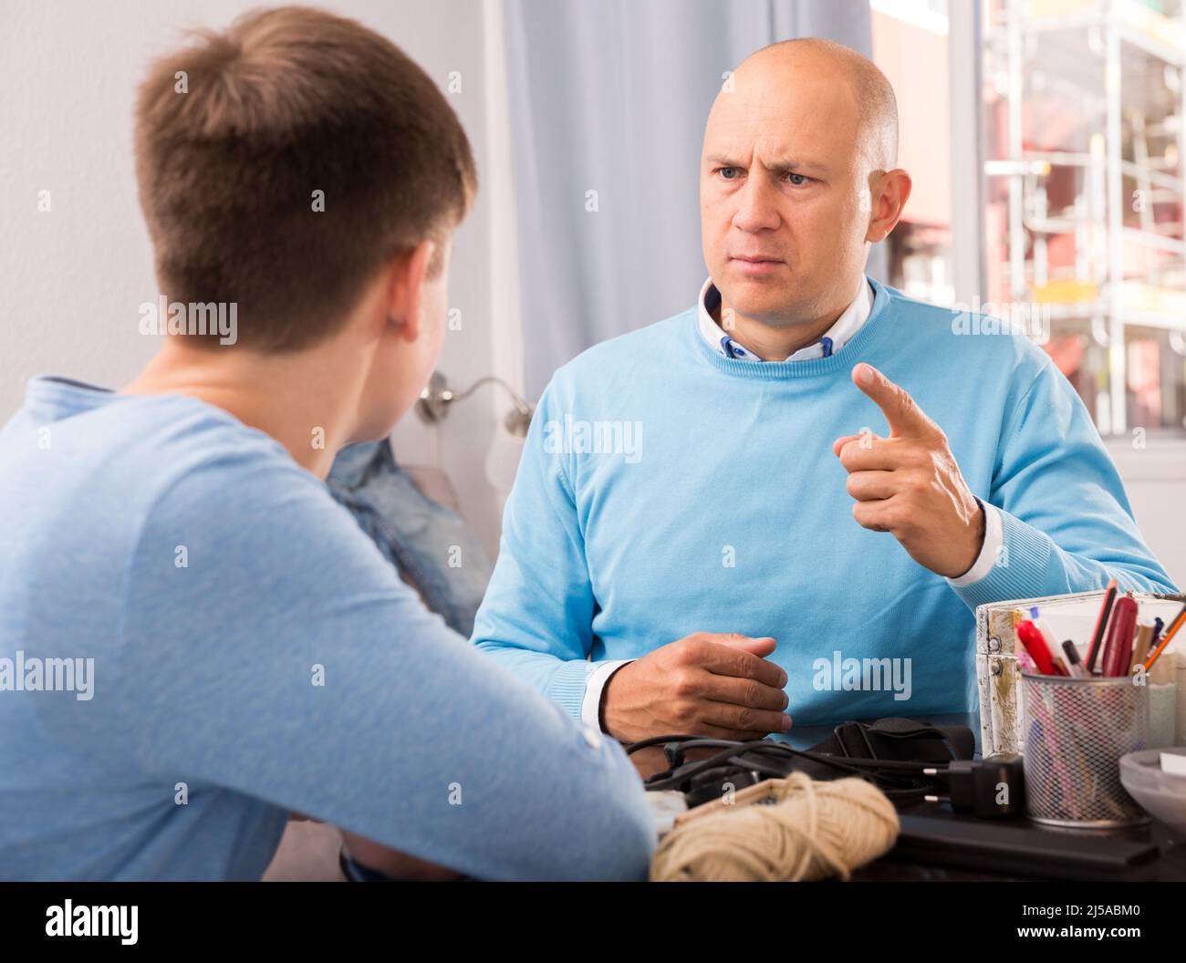 Strict father talking to son Stock Photo - Alamy