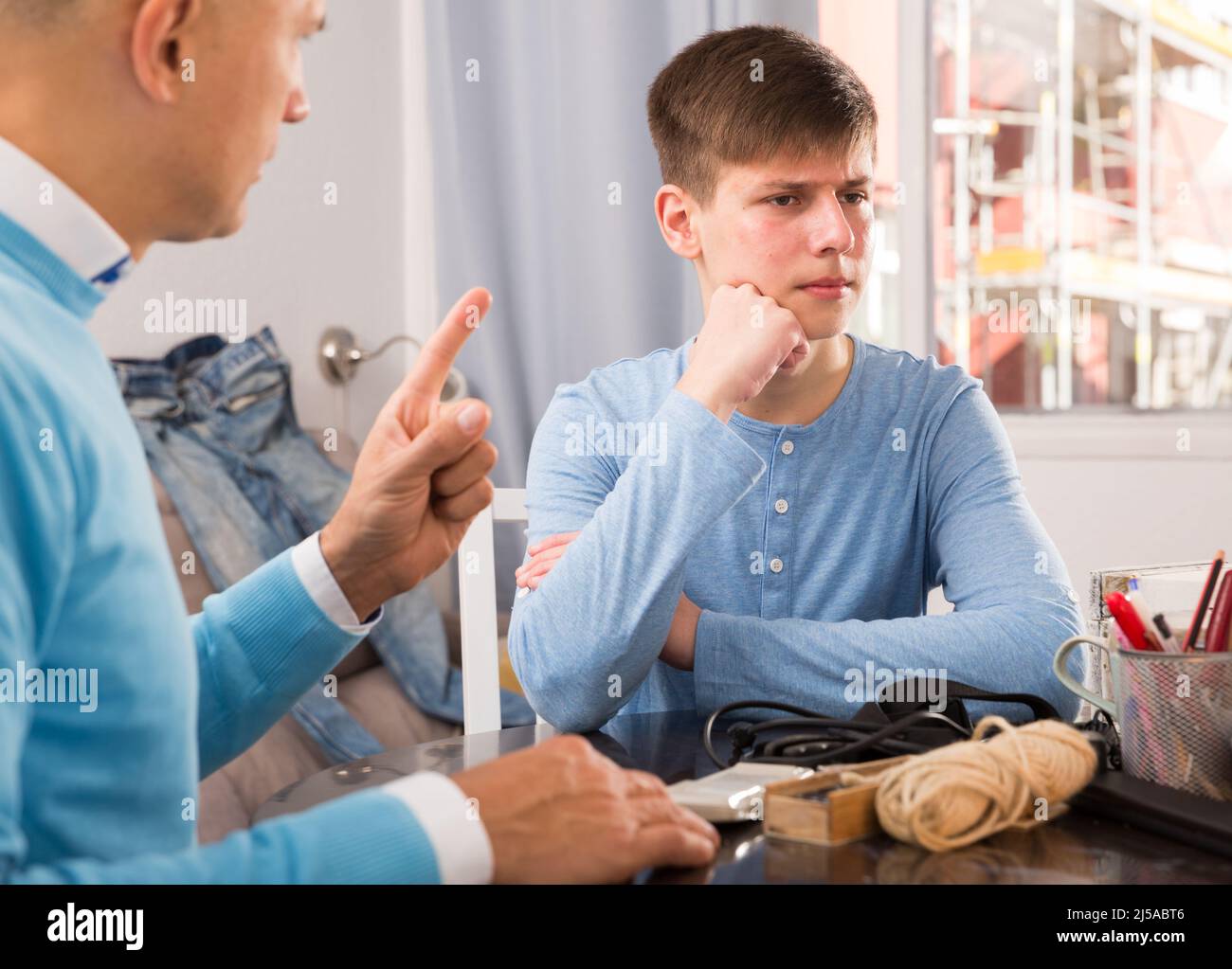 Serious father lecturing his son Stock Photo - Alamy