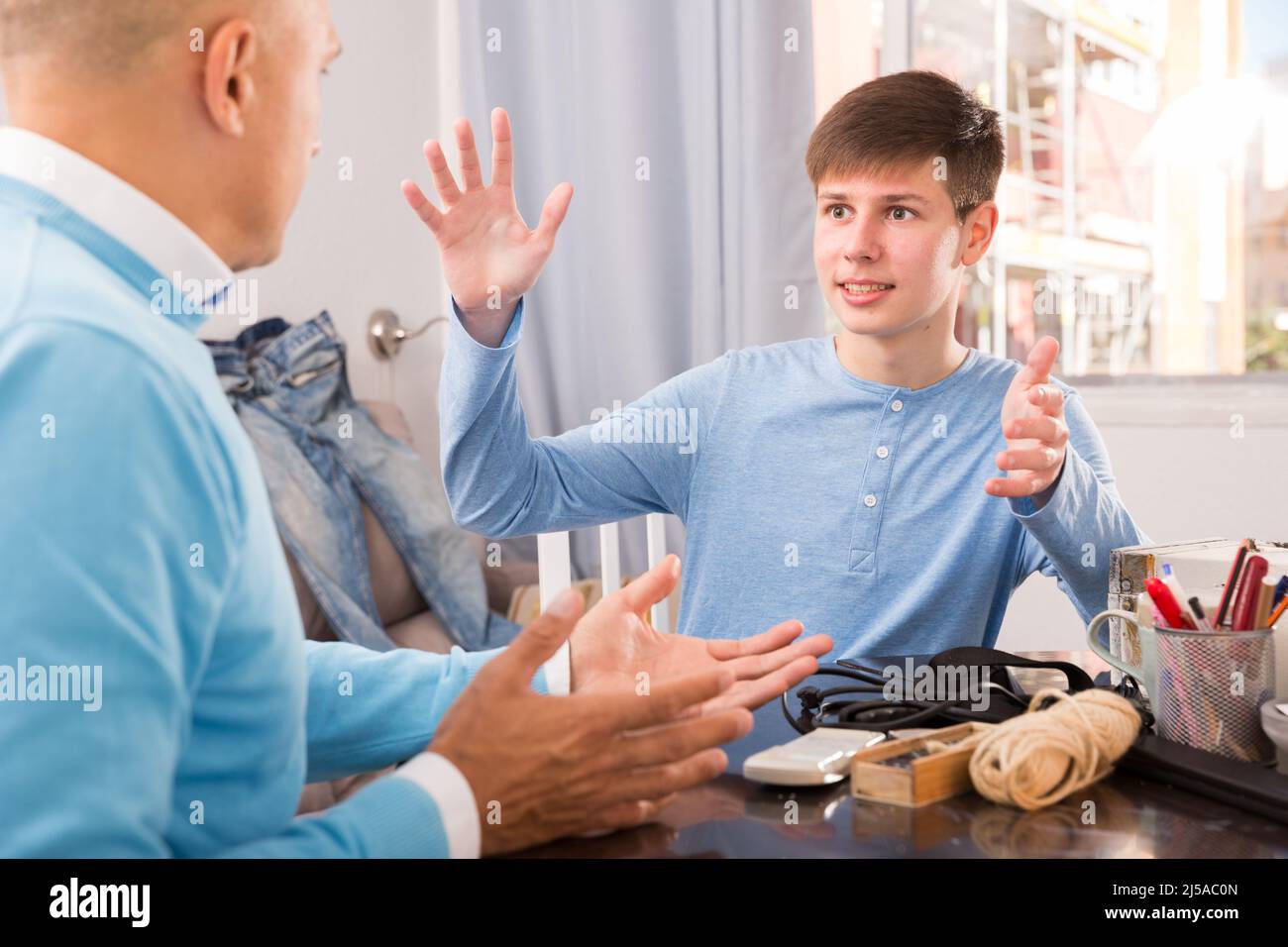 Son talking to father Stock Photo - Alamy