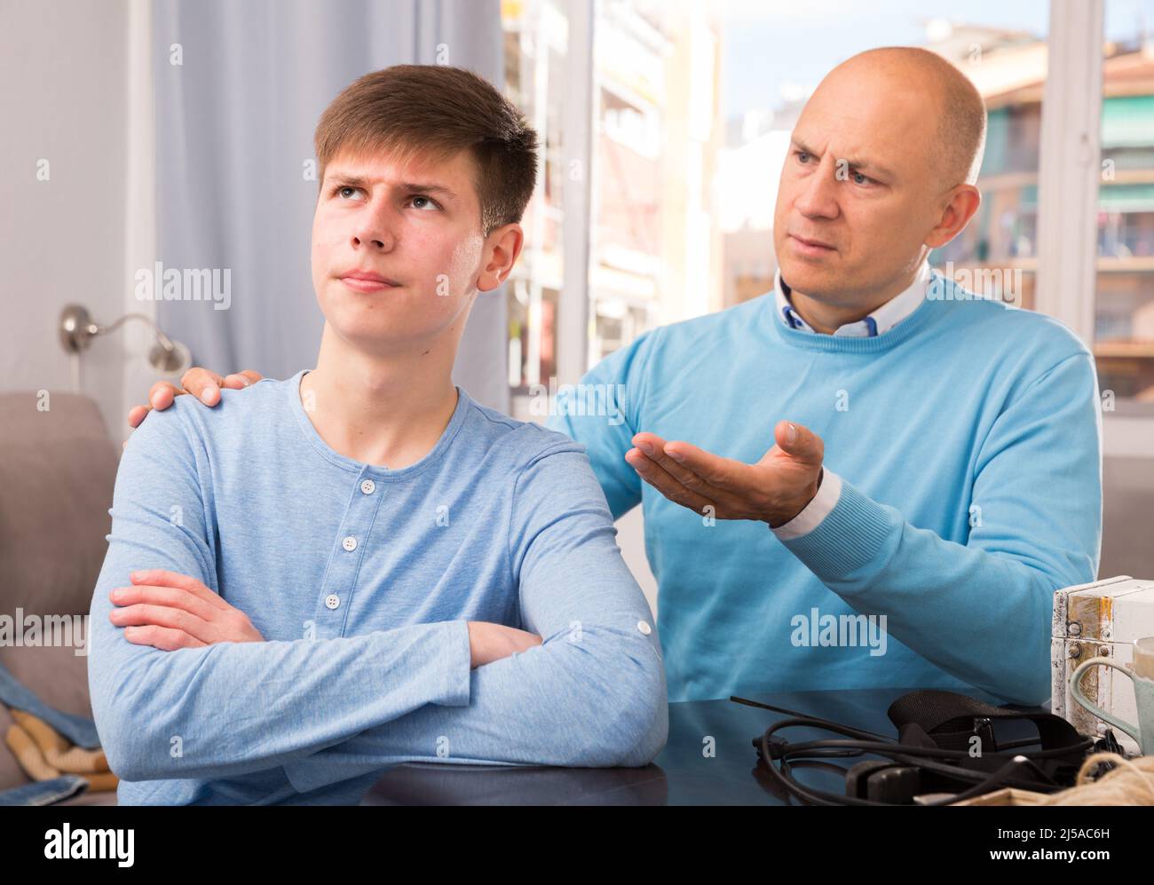 Father supporting his upset son Stock Photo - Alamy