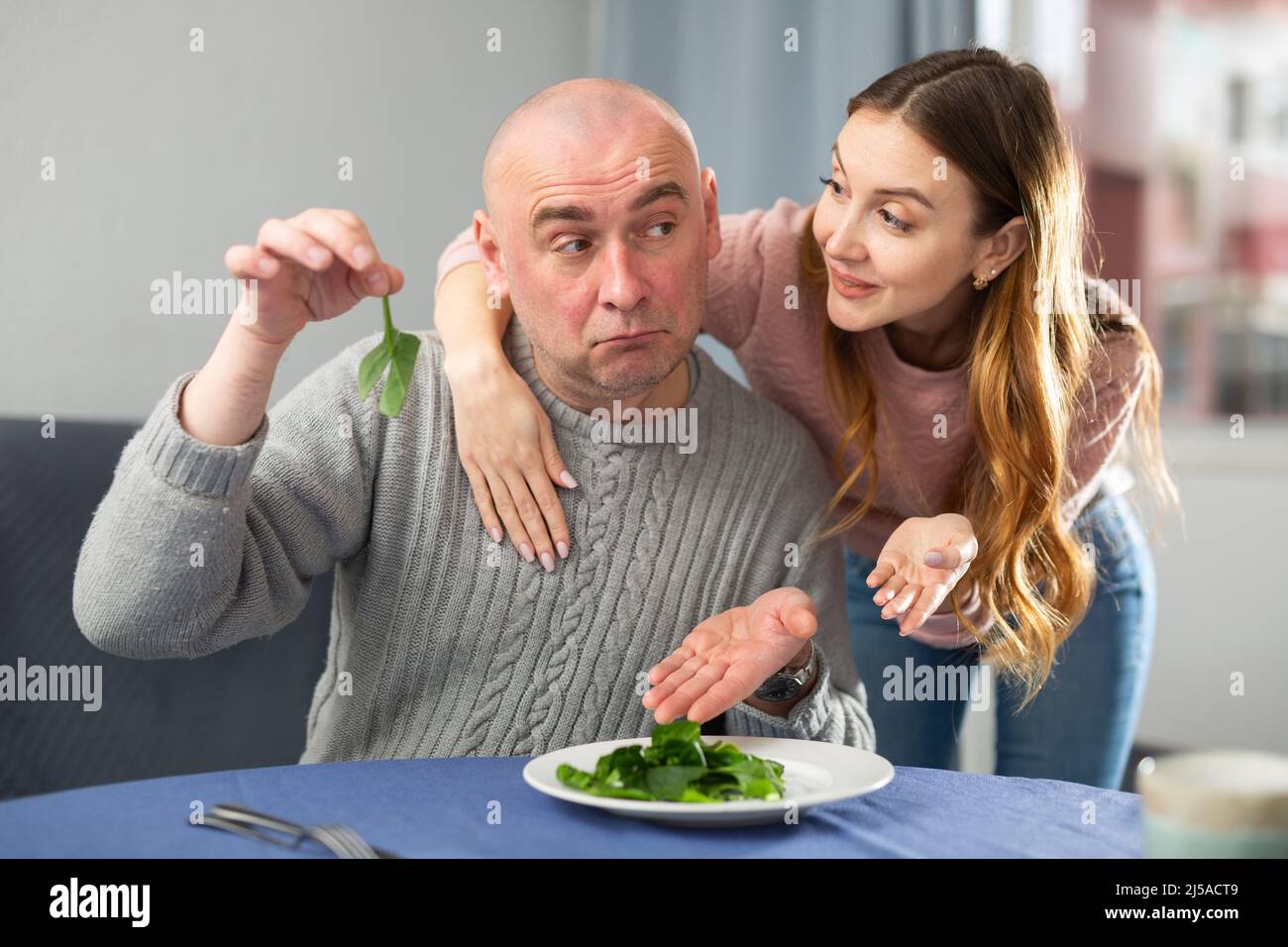 Man dissatisfied by dinner made by his wife Stock Photo - Alamy