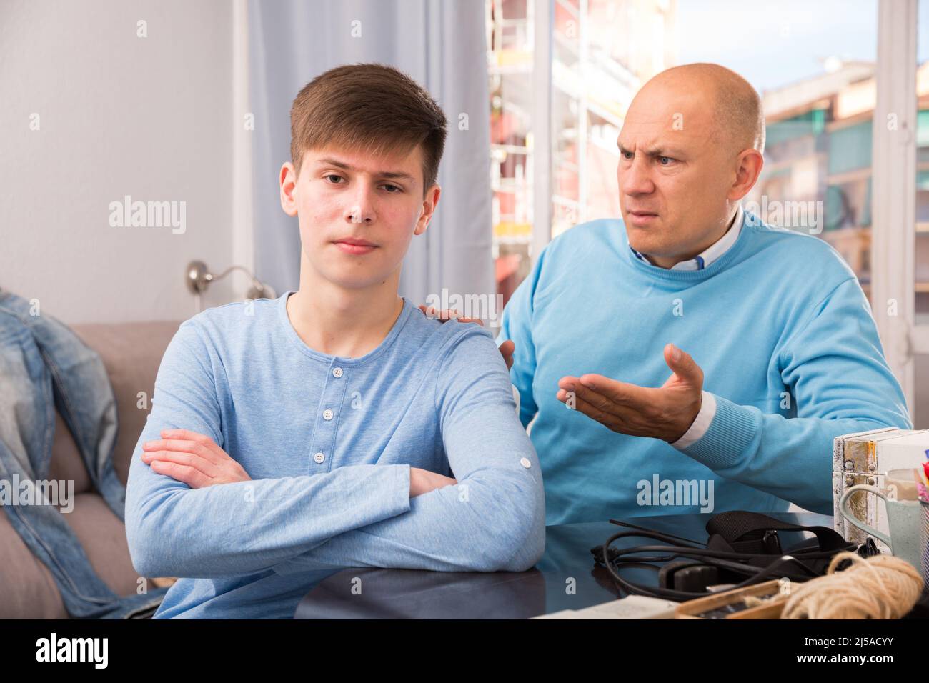 Father scolding his turned away son Stock Photo - Alamy
