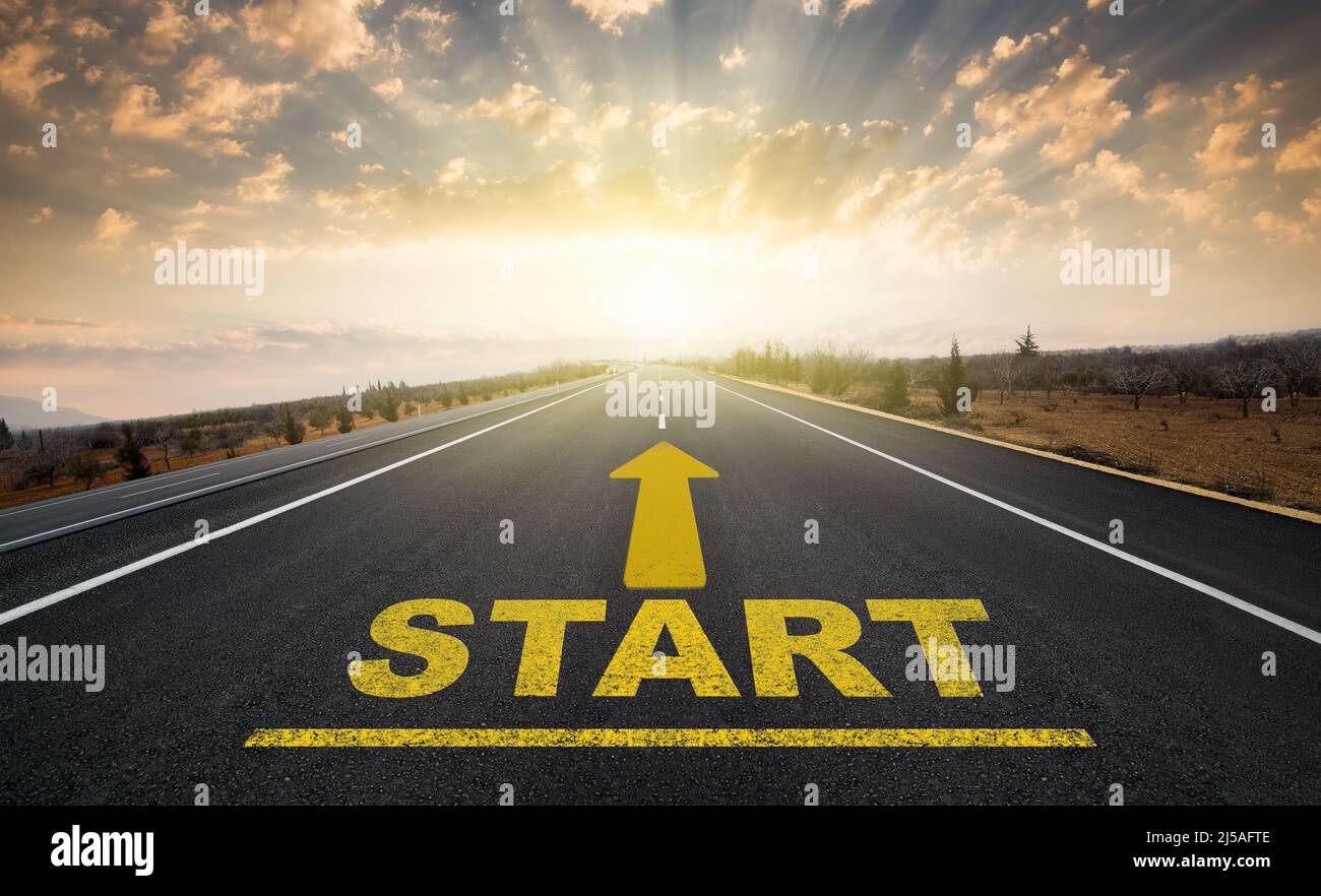 Start text written on empty road at sunrise. Business planning ...