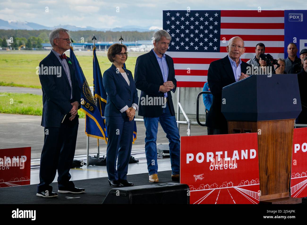 Rep. Peter DeFazio speaks to the audience, flanked by Reps. Blumenauer ...