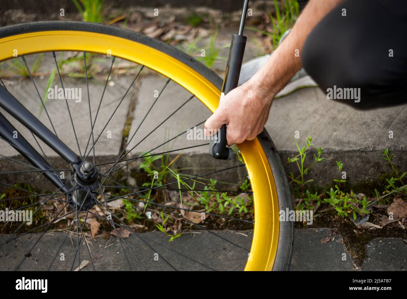 A young man pumps up the wheel of his Bicycle. It does this by using a ...