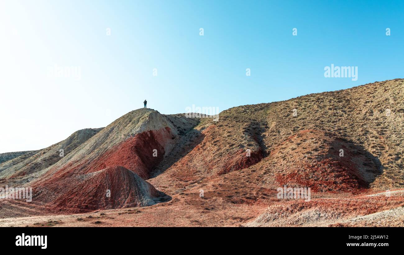 Photographer takes pictures of a beautiful red sandy mountain Stock ...